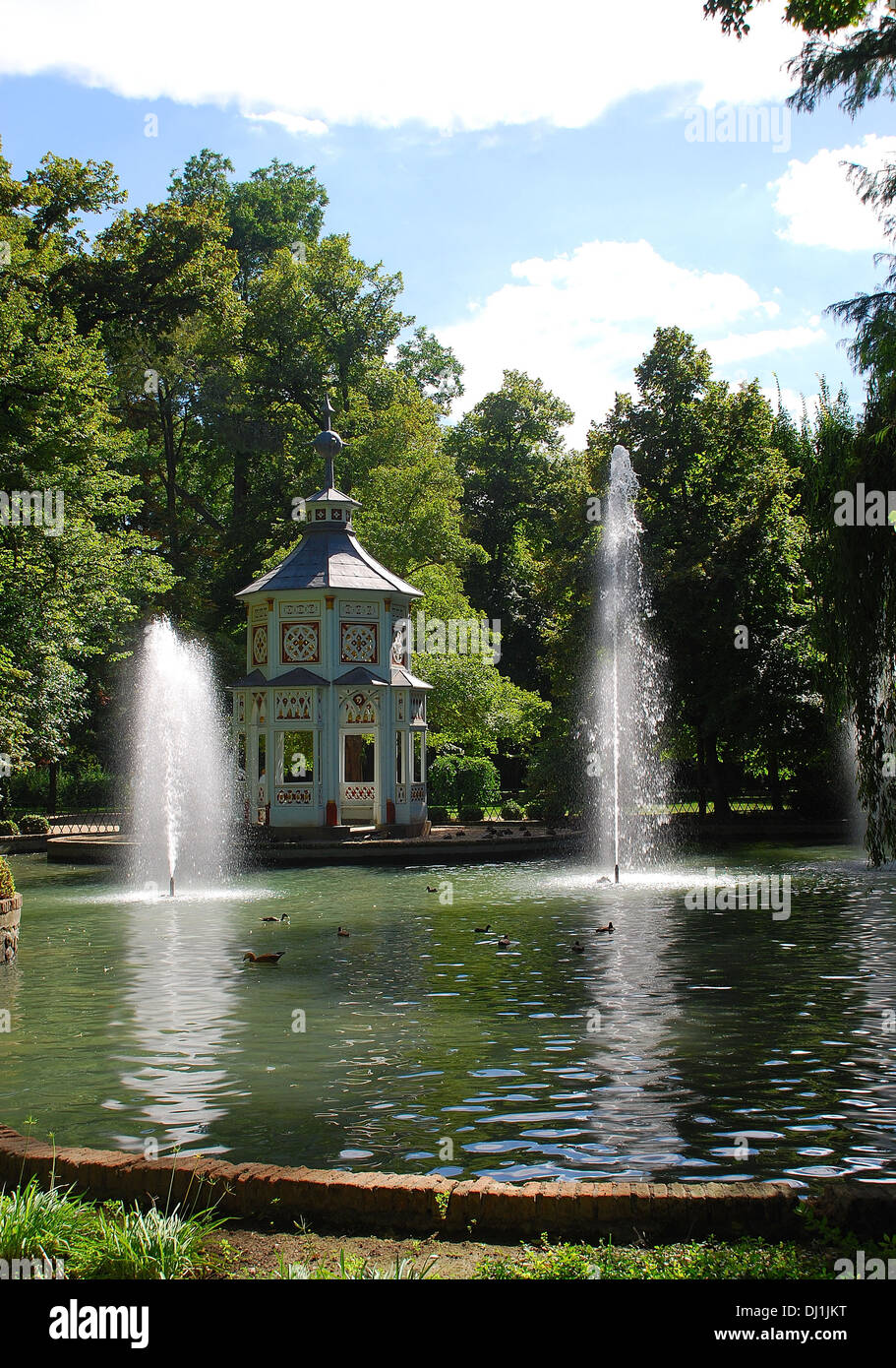 Temple on the lake and pumps near a green tree Stock Photo - Alamy