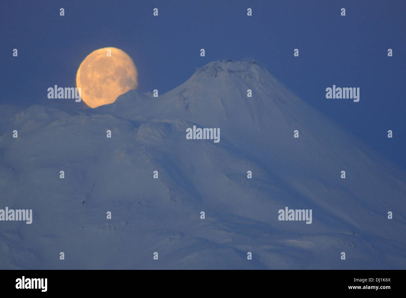 A full moon over Kikhpinych Volcano. Kronotsky Zapovednik, Kamchatka ...