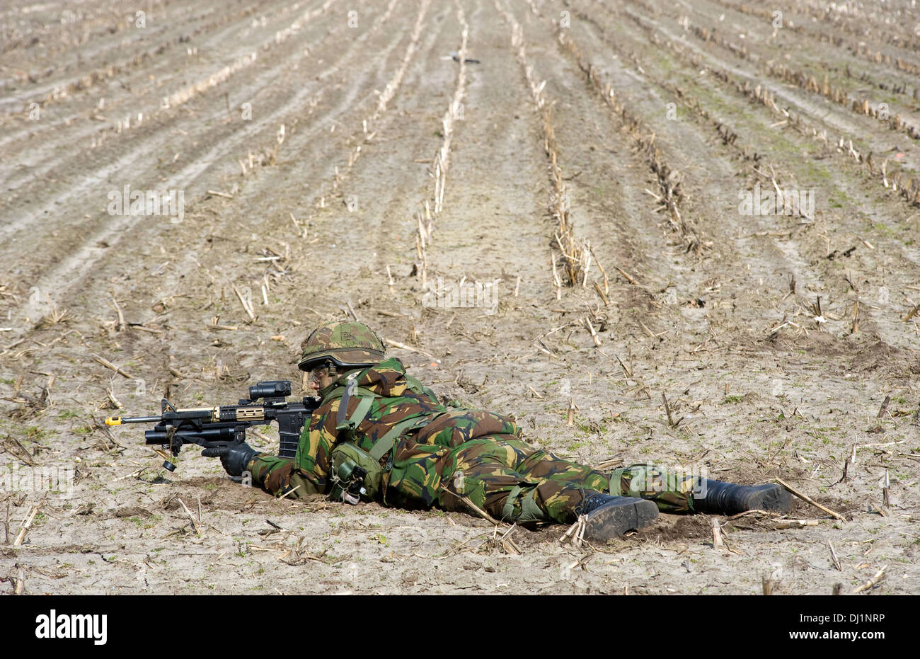 A soldier of the dutch army is aiming his automatic weapon during a ...