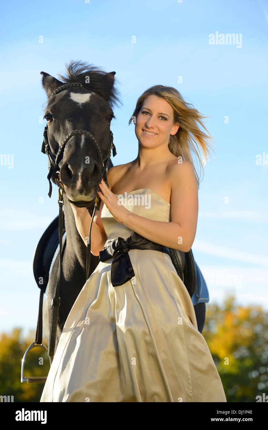 Young woman holding black Arab-Haflinger horse mix Model property ...