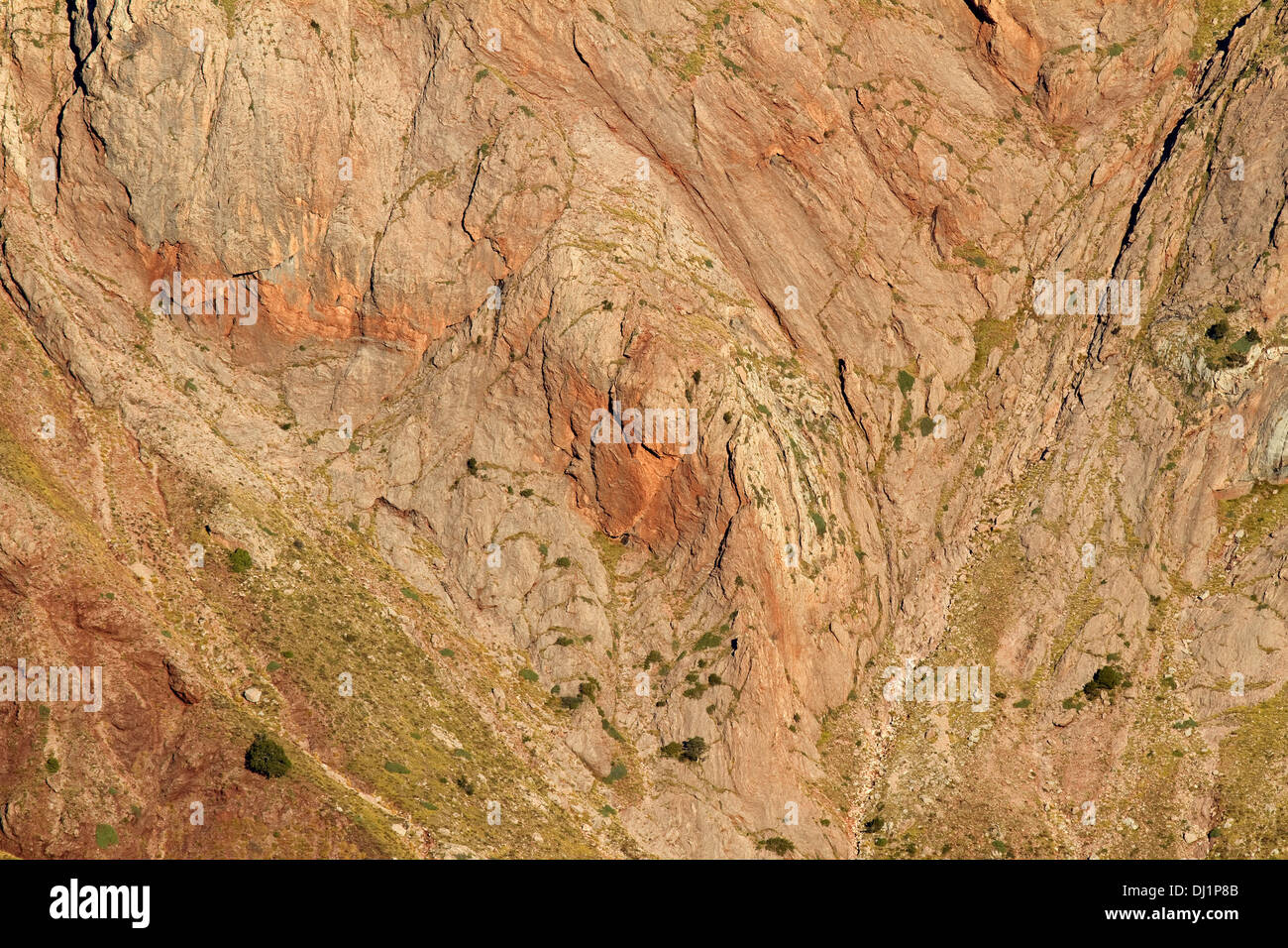 The reddish surface of a steep cliff of Vardousia Mountain, Greece ...