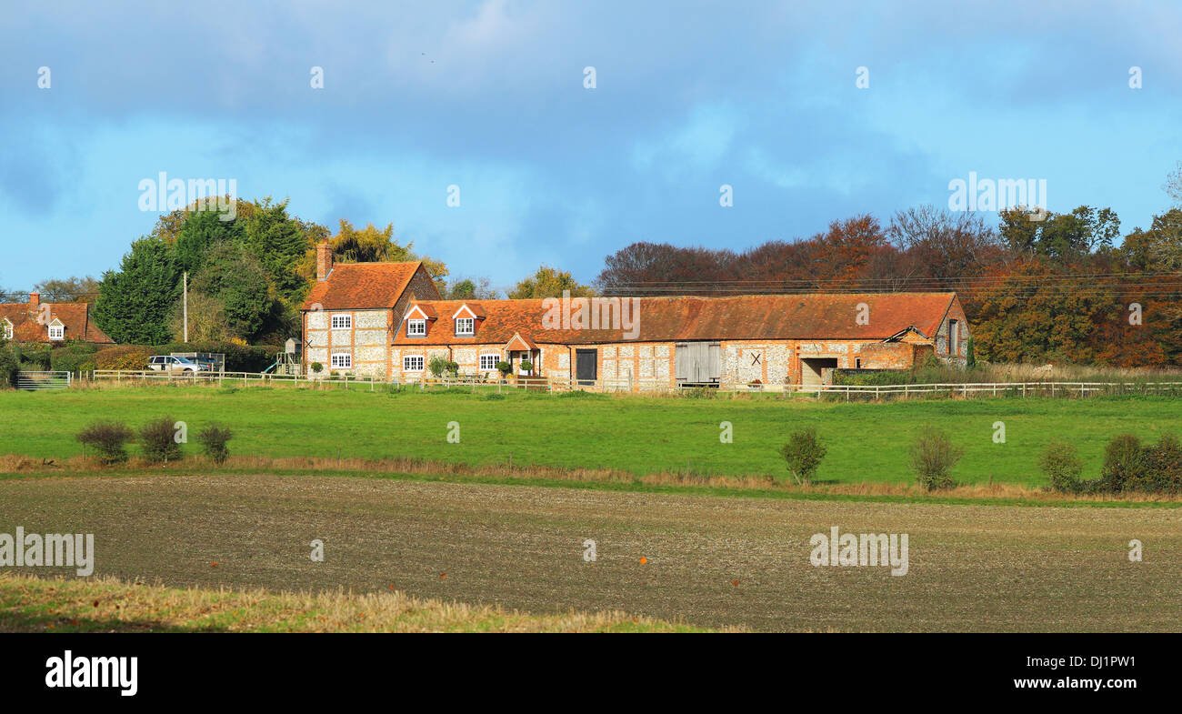 English Brick and Flint rural Farmhouse and Outbuildings with ploughed ...