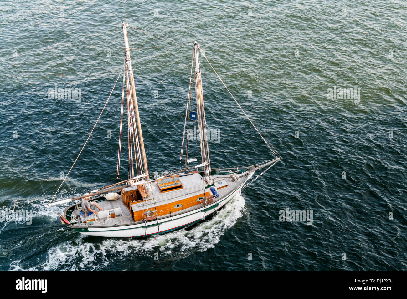 Wooden Sail Boat Motoring with Sails Down Stock Photo - Alamy