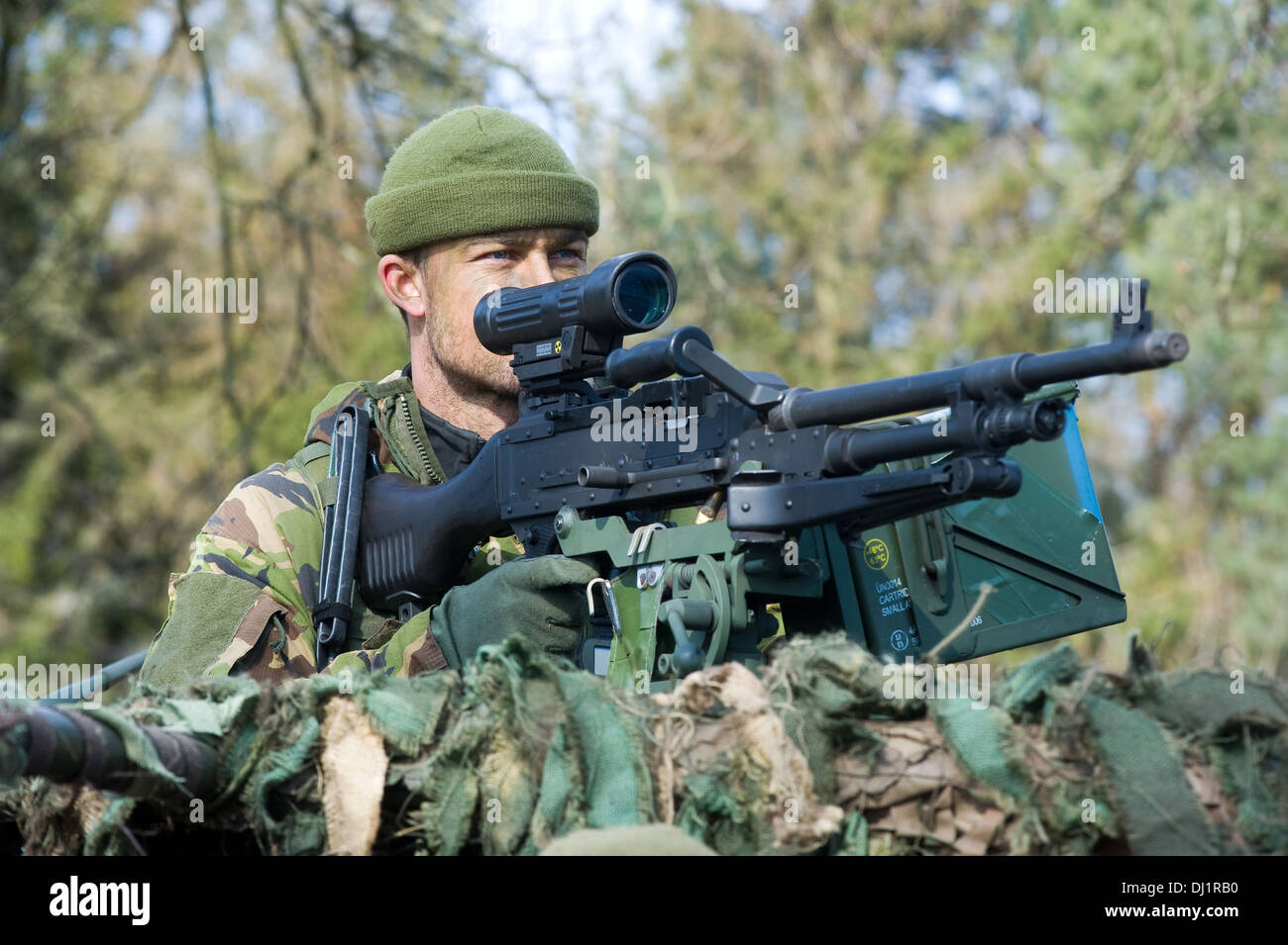A soldier of the dutch army is aiming his automatic weapon during a ...
