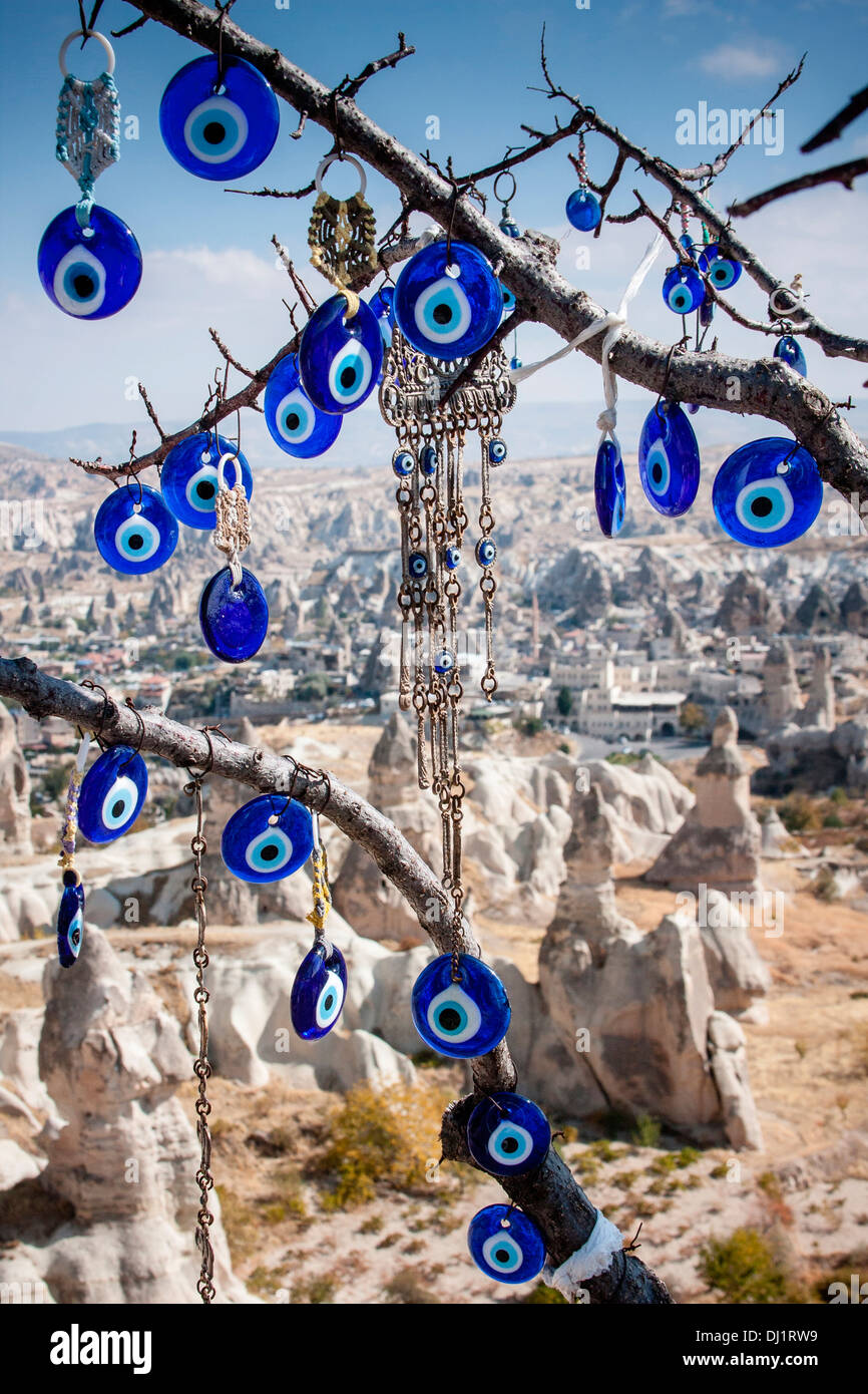 Cerulean blue glass charms of the Evil Eye are displayed in a tree at a ...