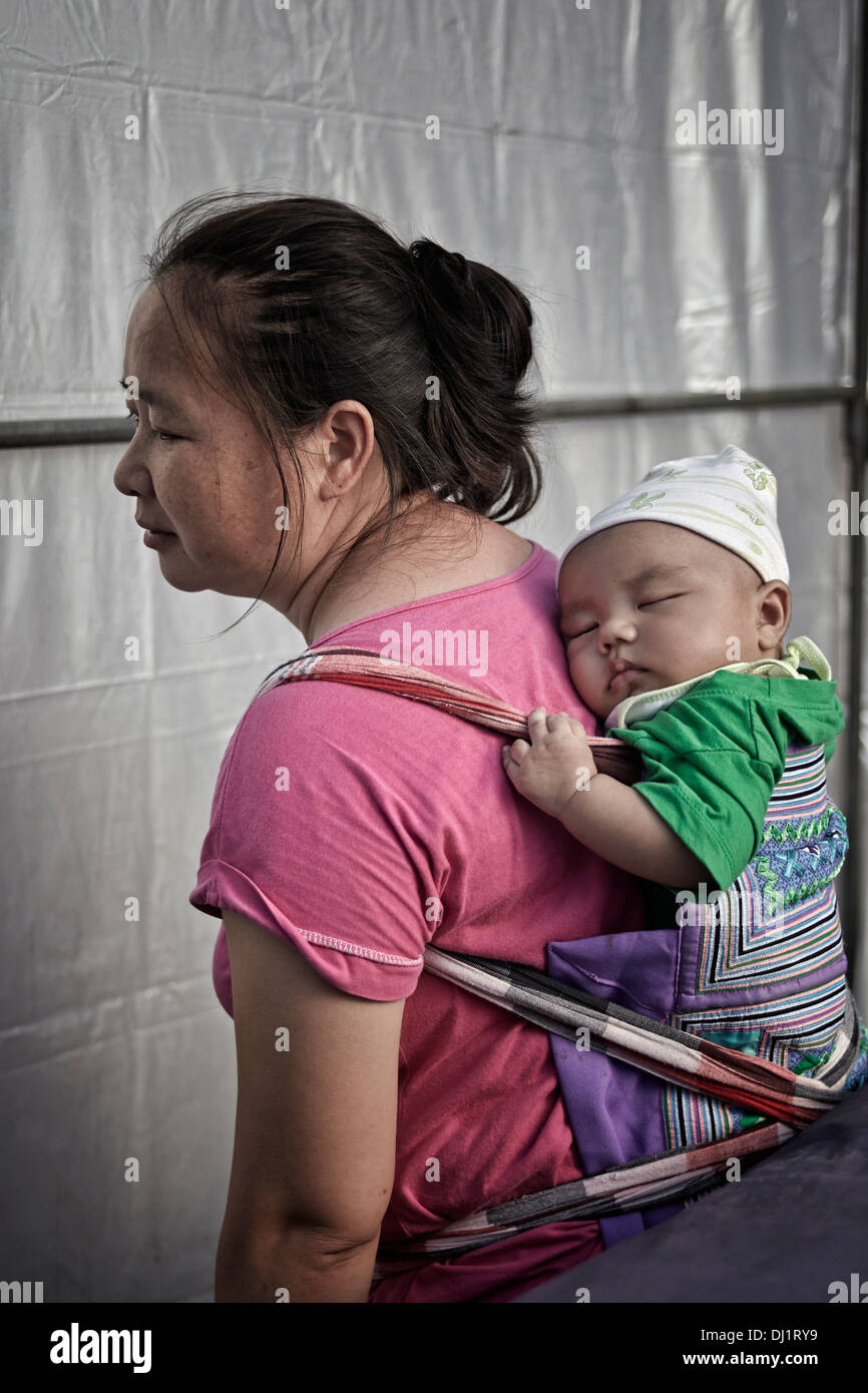 Thailand mother carrying infant child in a back sling. Thailand ...