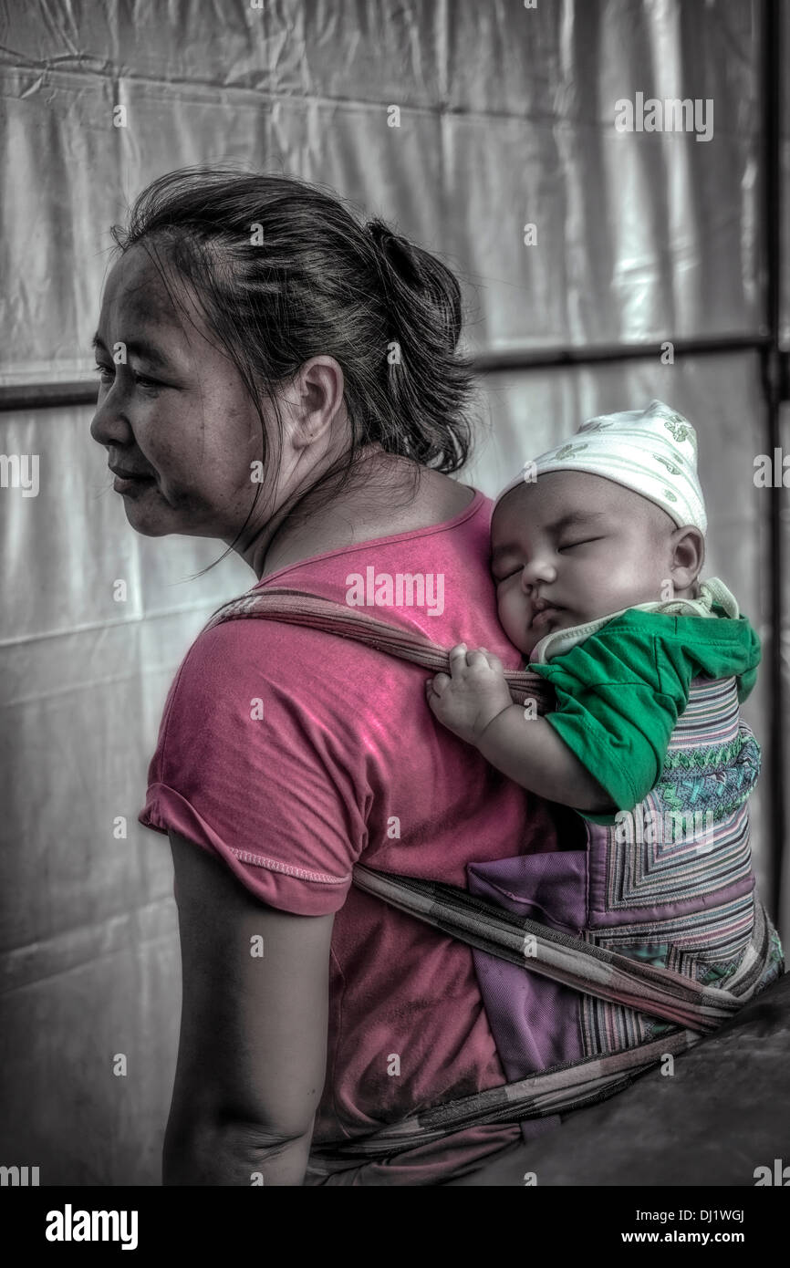 Thailand mother carrying infant child in a back sling. Thailand ...
