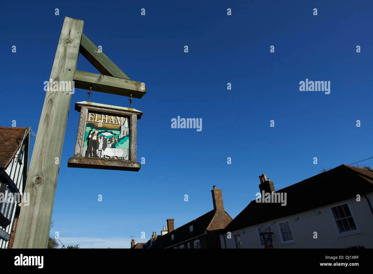 Traditional village sign for Elham Kent England against a blue sky ...