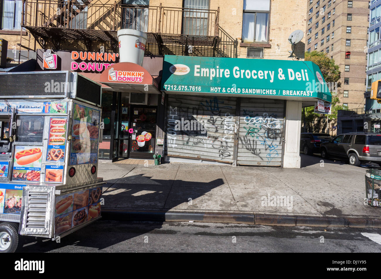 Parked hot dog cart, Dunkin Donuts and closed deli in the Chelsea ...