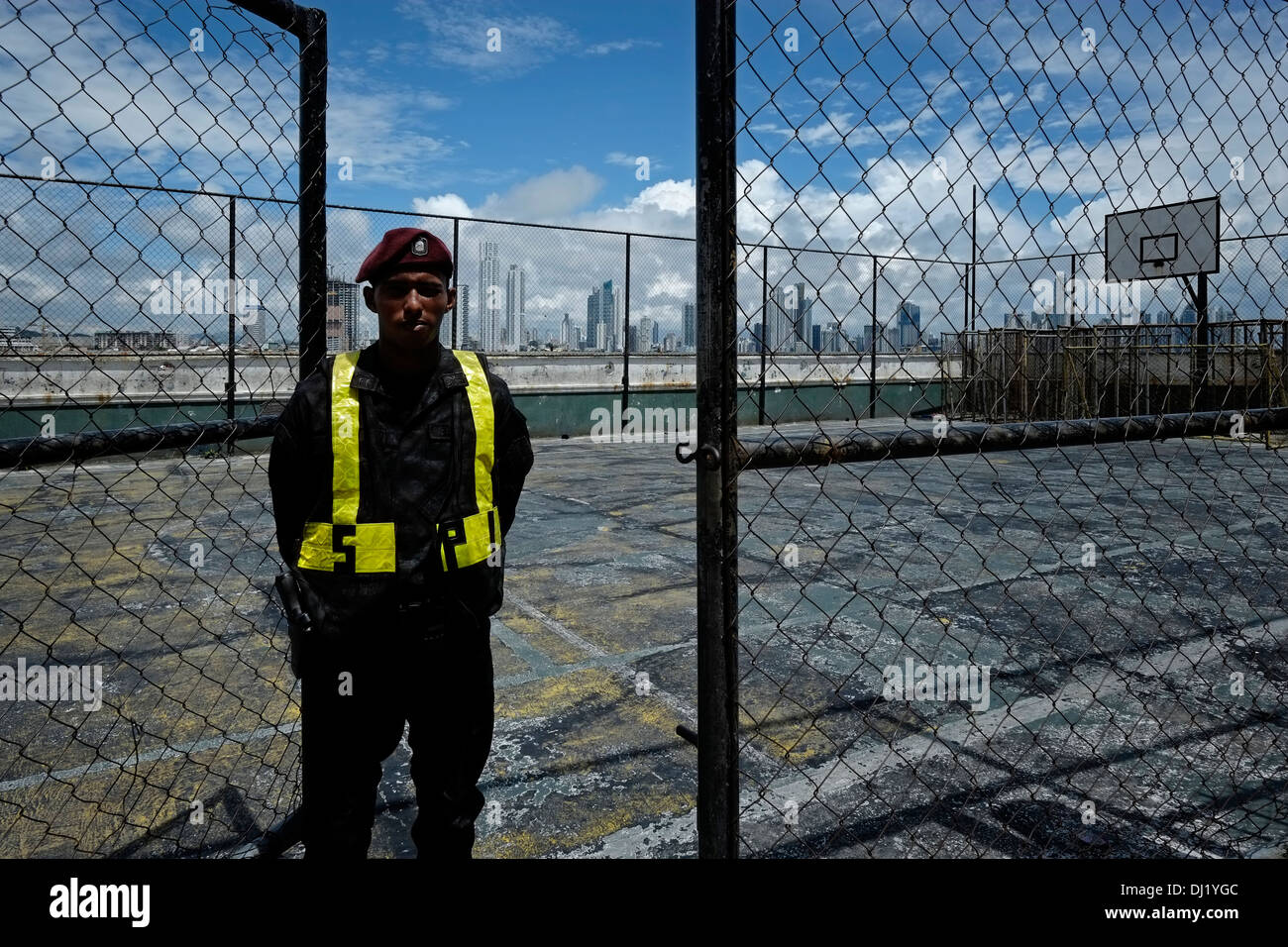 An armed security man stands guard at the entrance to a basketball ...