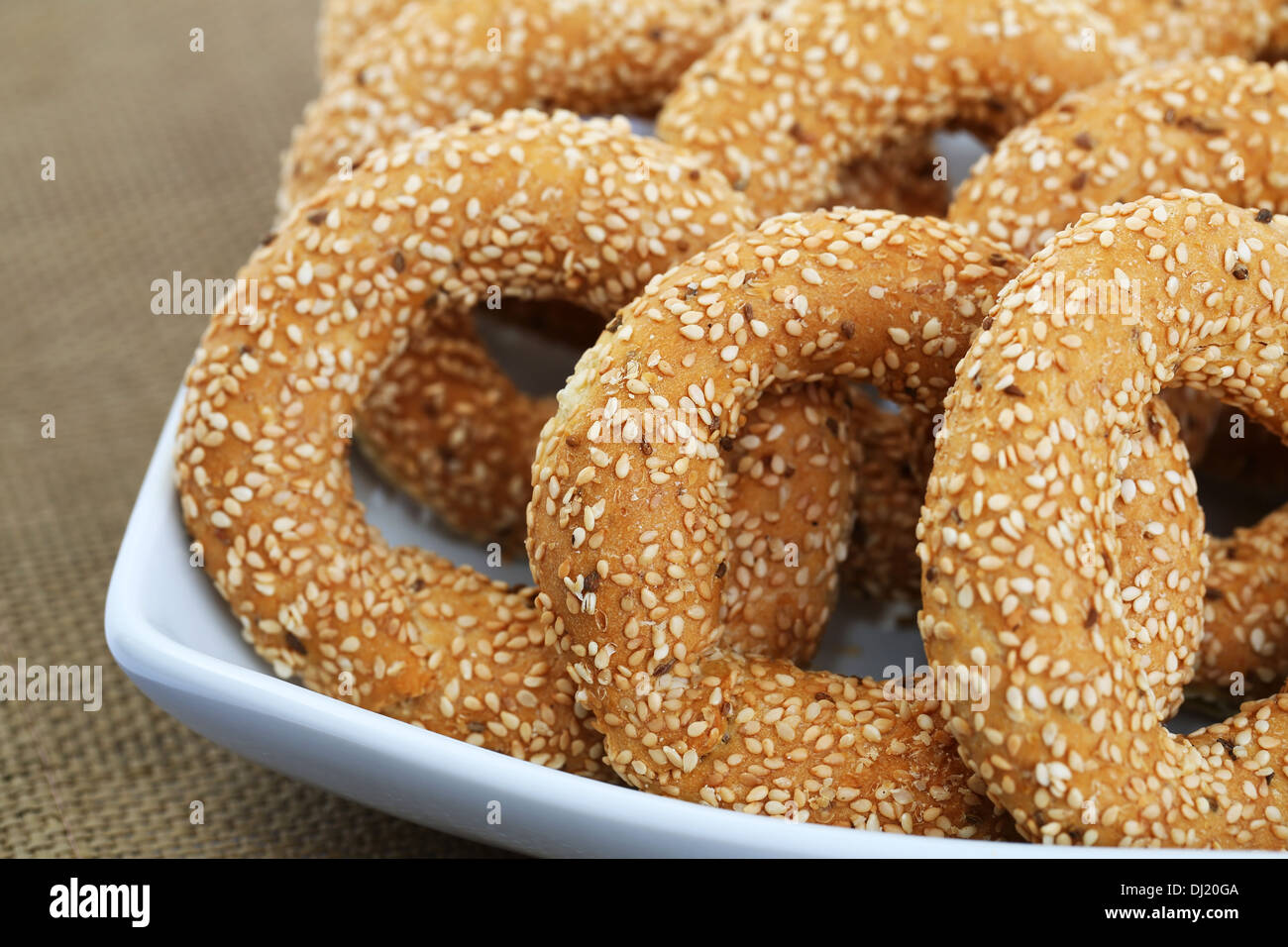 Round rusks with sesame seeds in white bowl Stock Photo - Alamy