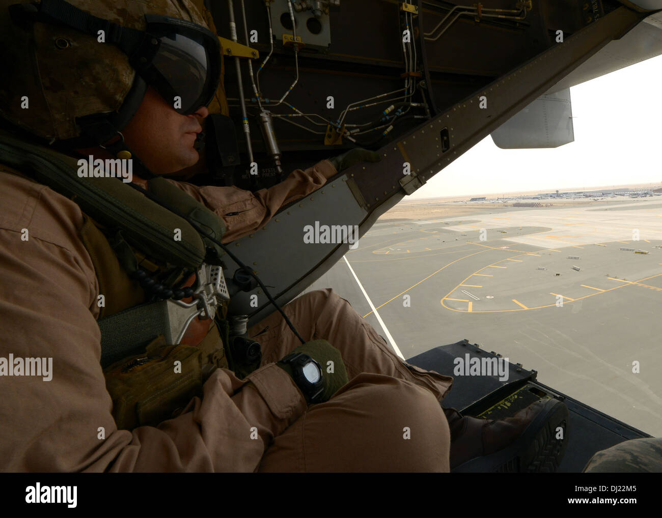 U.S. Marine Corps Sgt. Devon Morris looks down at the other aircraft at ...