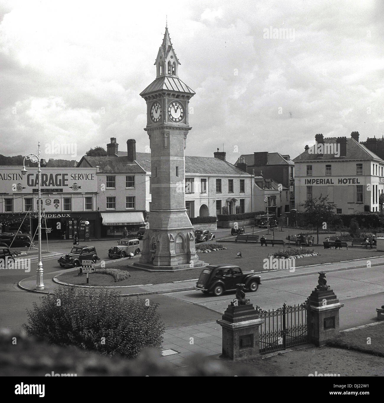 1950s historical picture of a clock tower in a town square in England ...