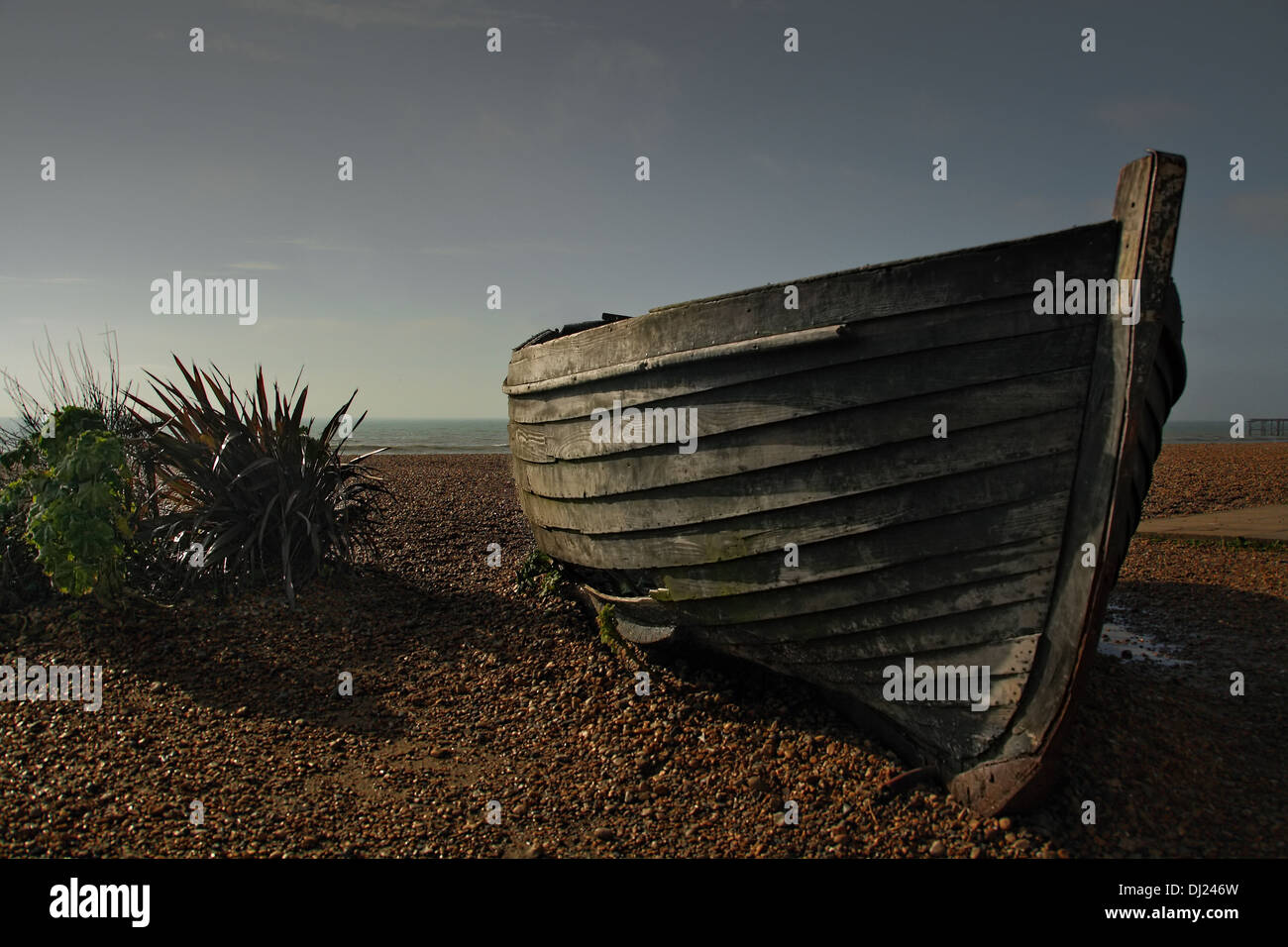 old fishing boat beached on a shingle beach Stock Photo - Alamy