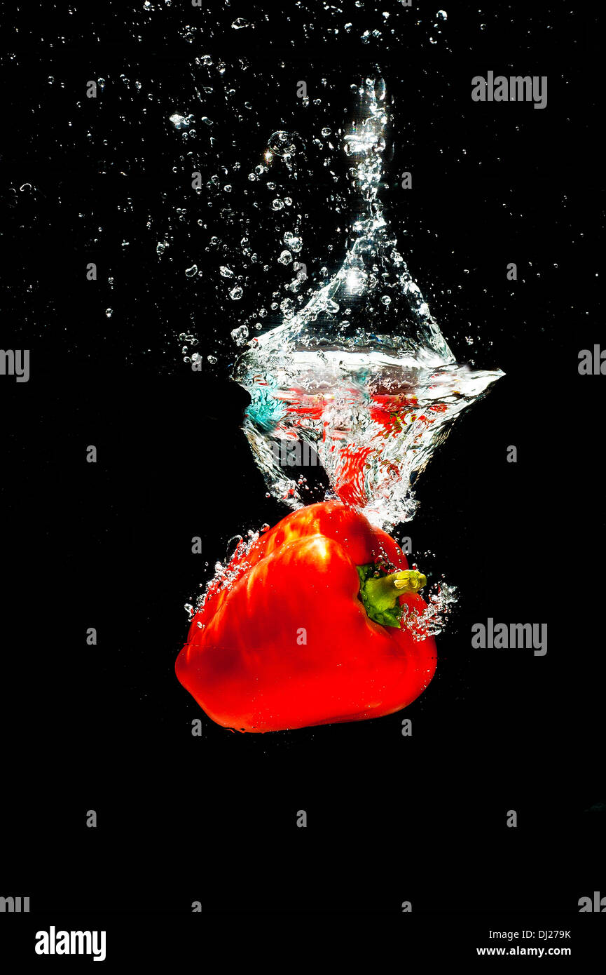 Pepper splashes in water Stock Photo - Alamy