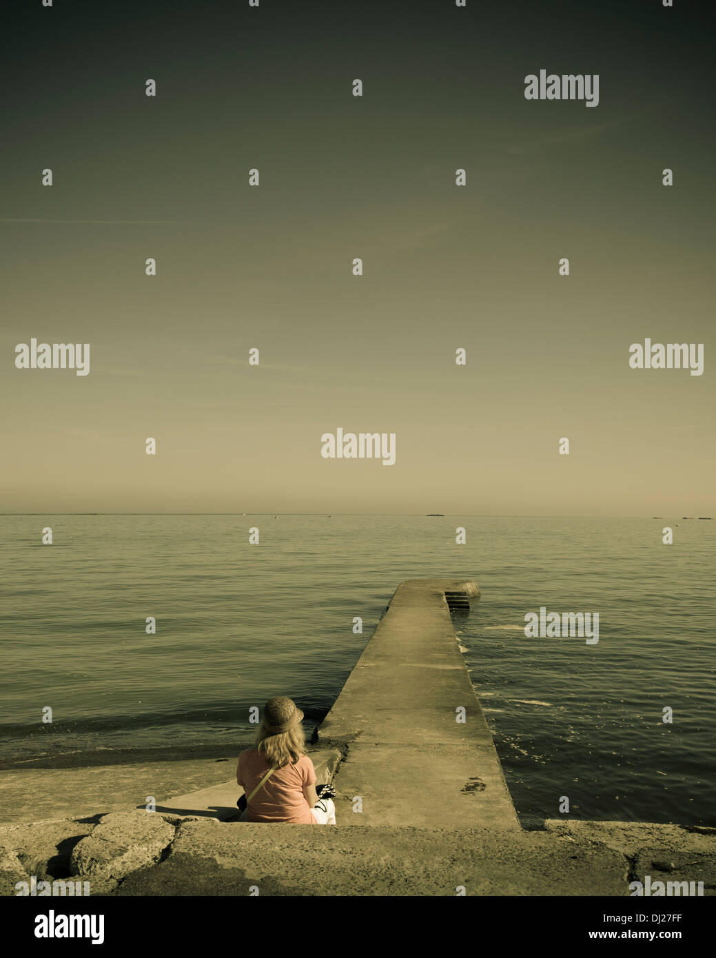 A person looking out to sea at something unseen Stock Photo - Alamy