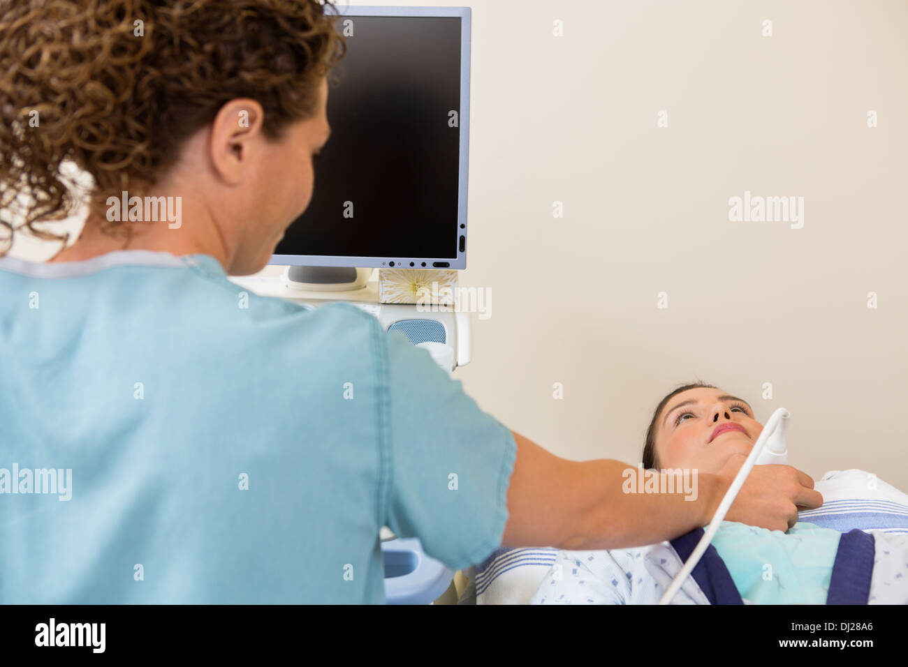 Nurse Scanning Female Patient's Neck Stock Photo - Alamy