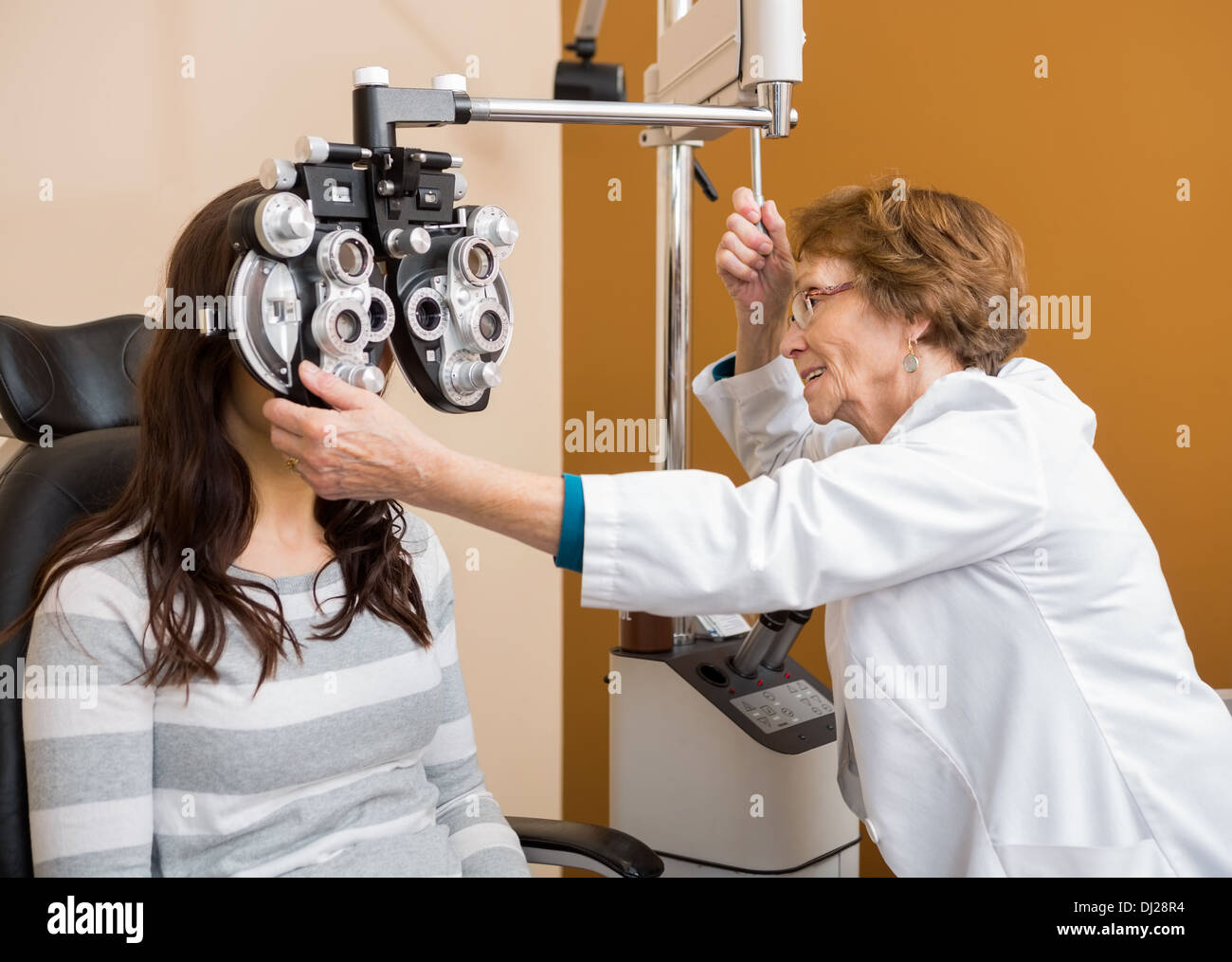 Doctor examining senior womans eyes hi-res stock photography and images ...