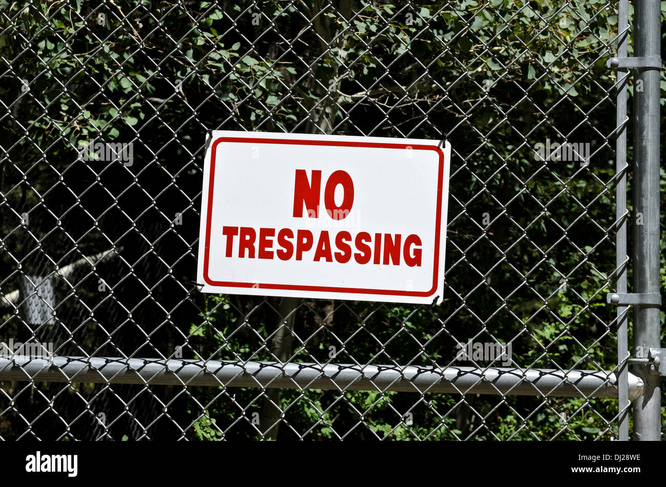 Red on white no trepassing sign Stock Photo - Alamy