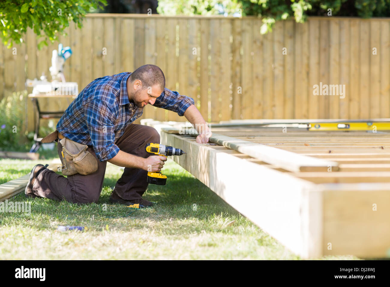 Carpenter Drilling Wood At Construction Site Stock Photo - Alamy