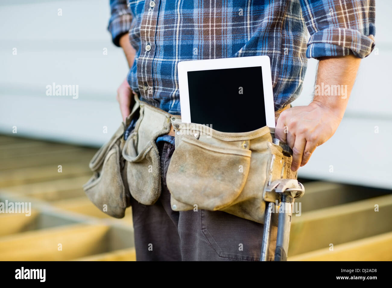 Construction Worker With Tablet Computer In Toolbelt Stock Photo - Alamy
