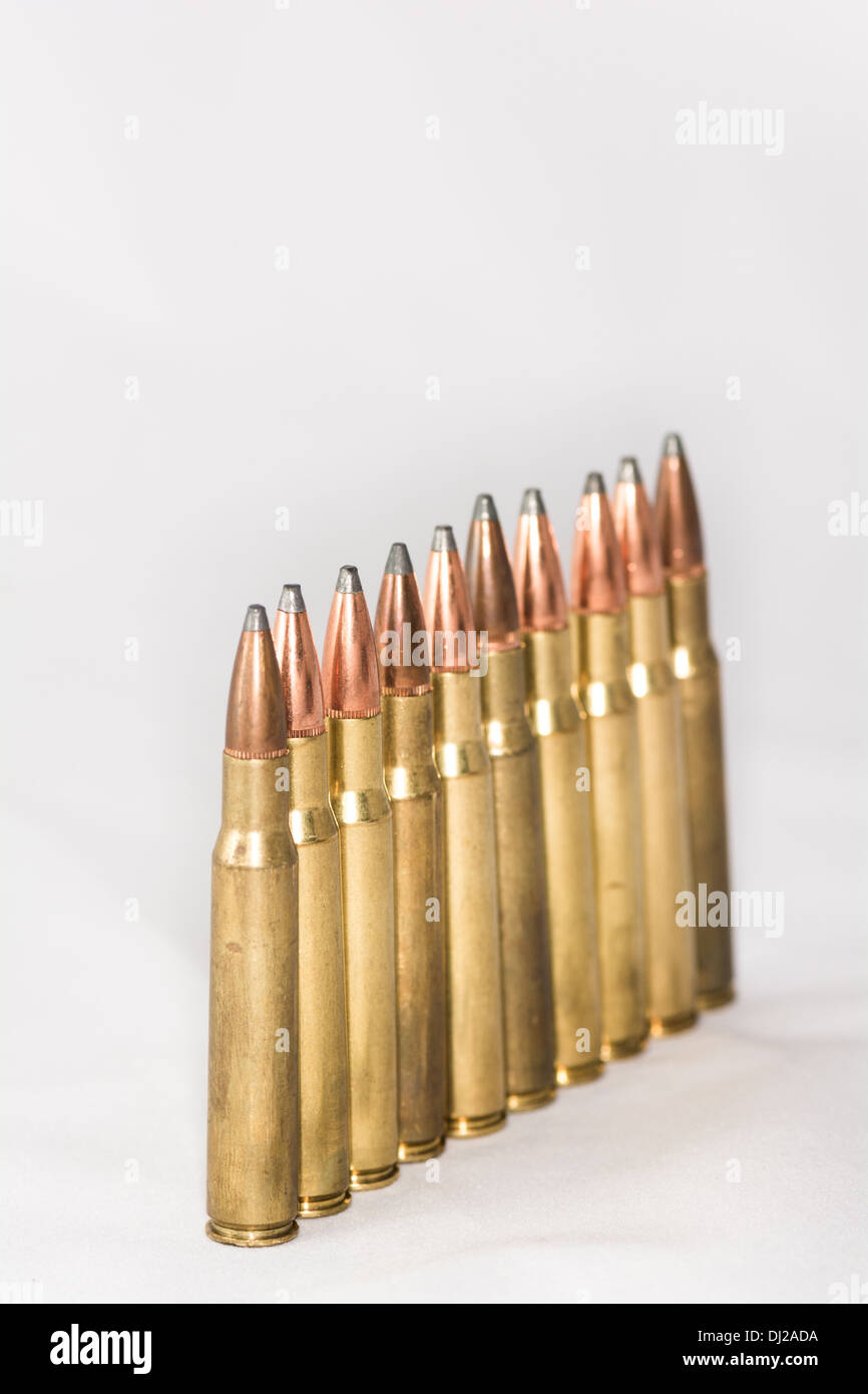 A few rifle bullets lined up in a row on white background Stock Photo ...