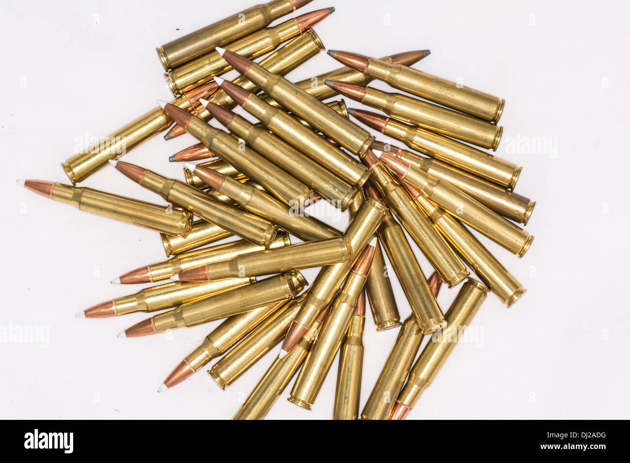 Pile of loaded rifle bullets isolated with white background with ...