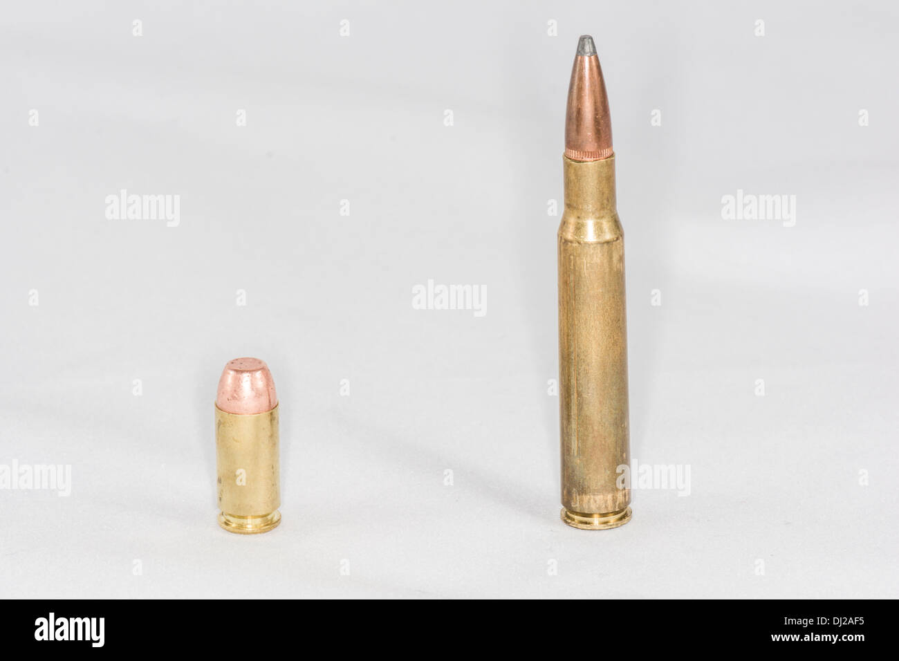 Hand gun and rifle bullets on white background with detail Stock Photo ...