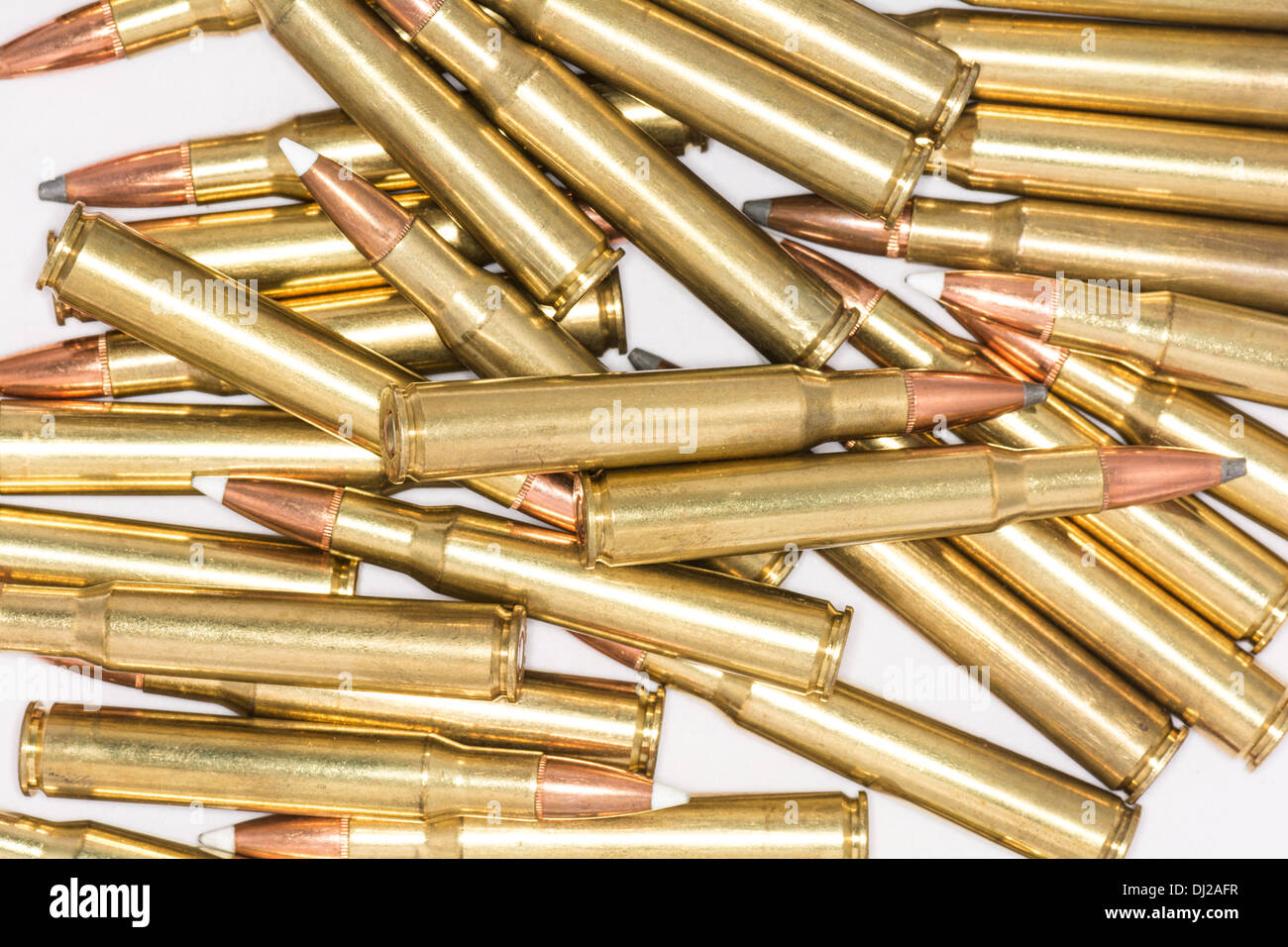 Pile of loaded rifle bullets isolated with white background with ...