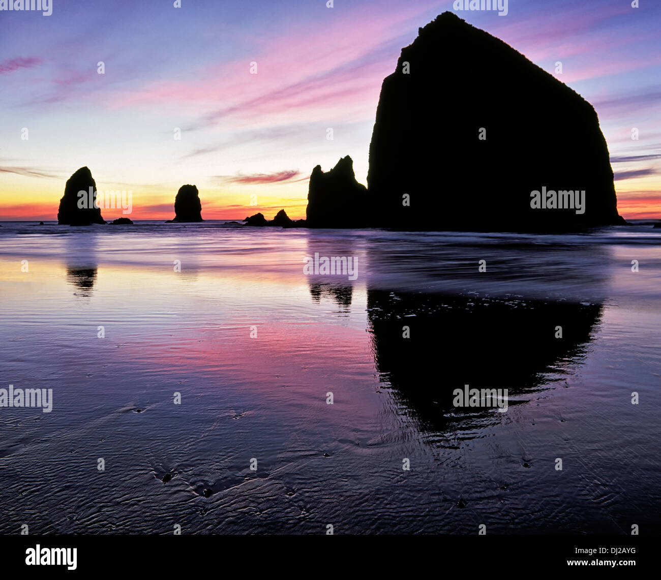 Last hues of sunset silhouette Haystack Rock and the offshore "Needles ...