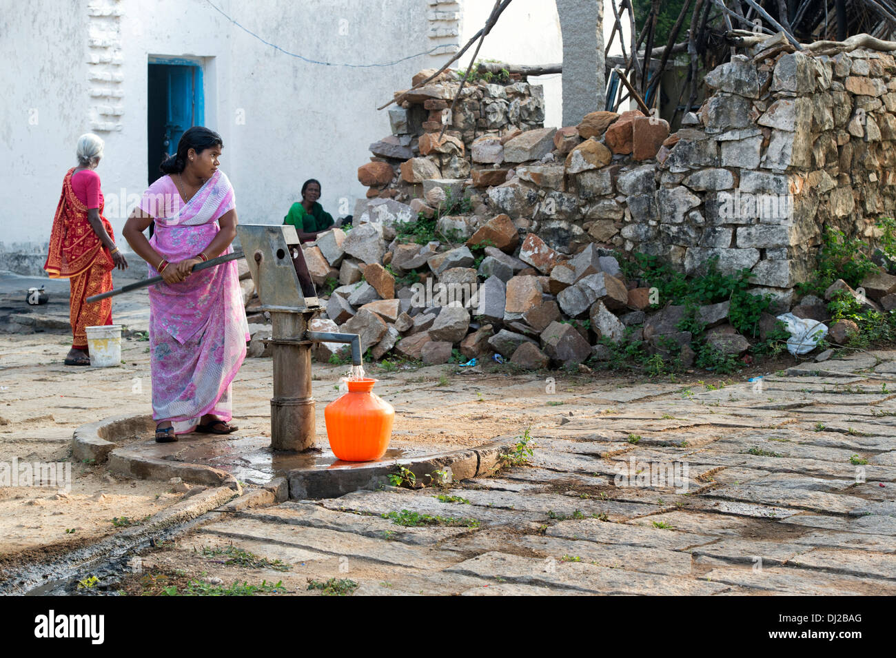Indian woman filling plastic water hi-res stock photography and images ...
