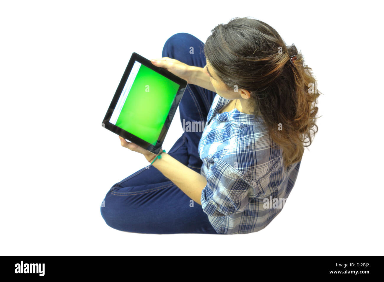 Young woman sitting on the floor using a tablet Stock Photo - Alamy