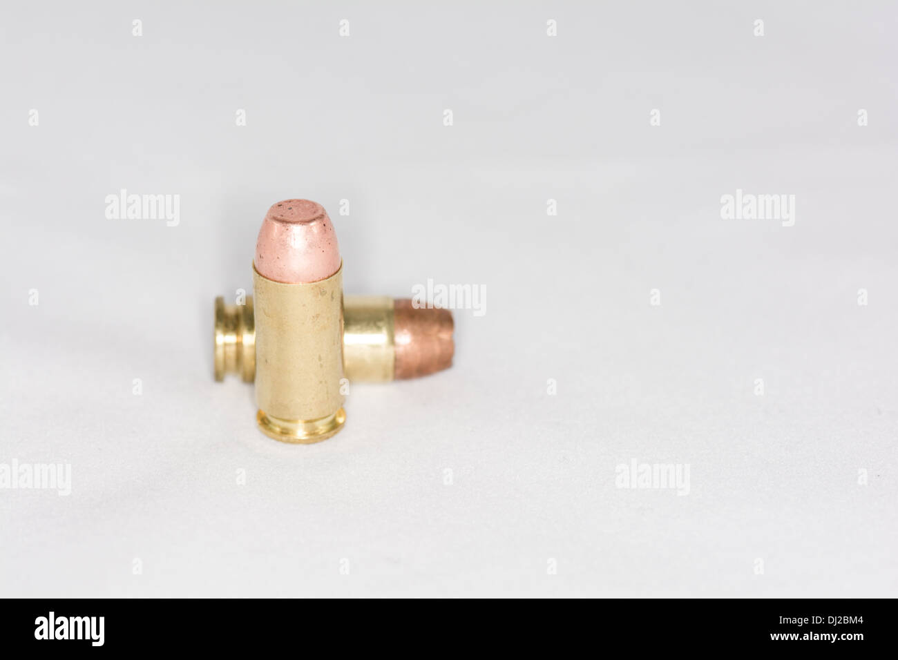 Two hand gun bullets on white background with detail Stock Photo - Alamy
