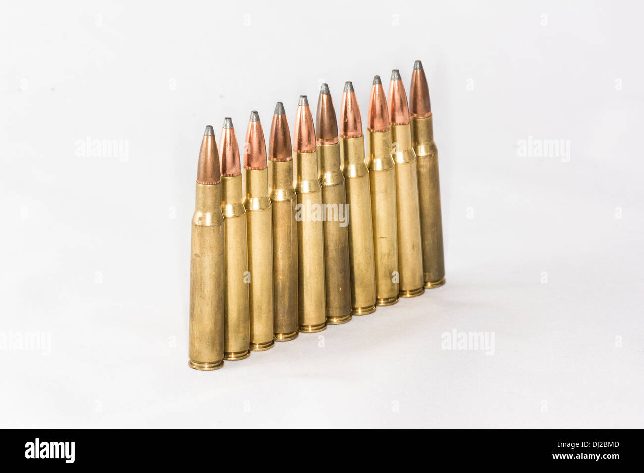 A few rifle bullets lined up in a row on white background Stock Photo ...
