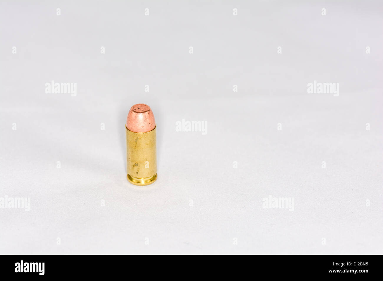 Hand gun bullet on white background with detail Stock Photo - Alamy