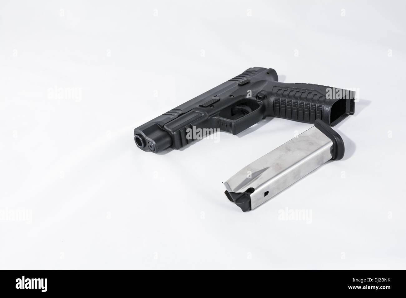 Black hand gun on white background unloaded and safe Stock Photo - Alamy