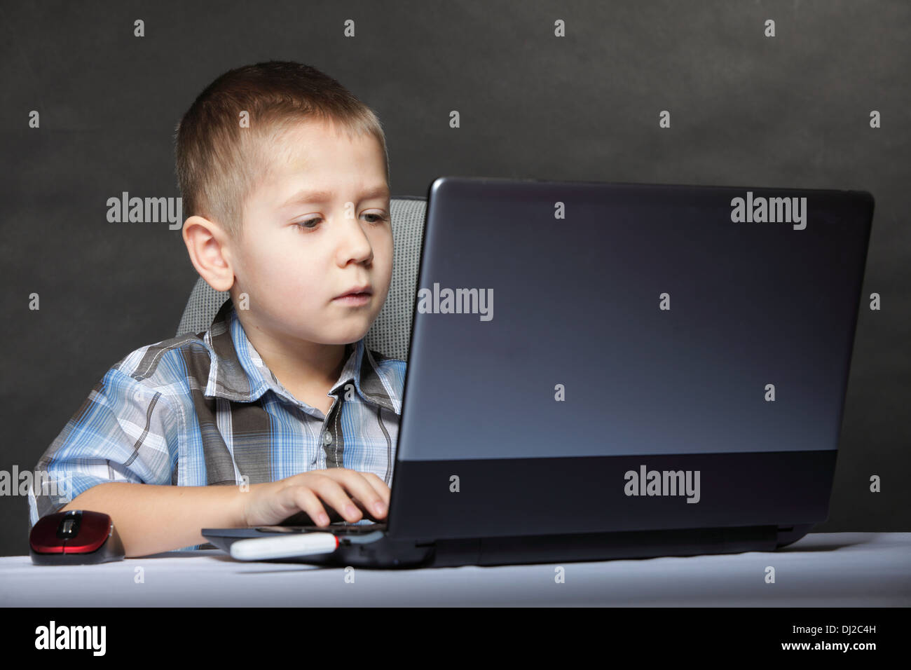 Computer addiction child boy with laptop notebook black background ...