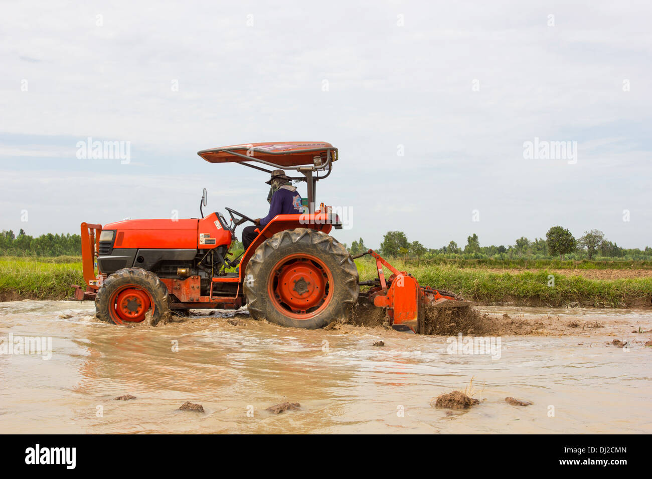 Farmer using tractors for agriculture Stock Photo - Alamy