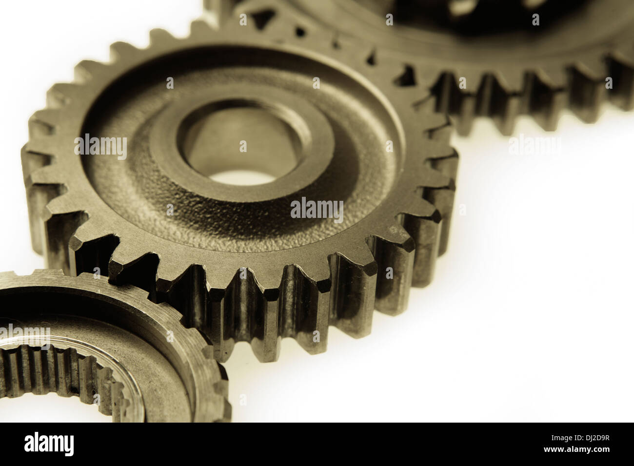 Metal cog gears joining together Stock Photo - Alamy