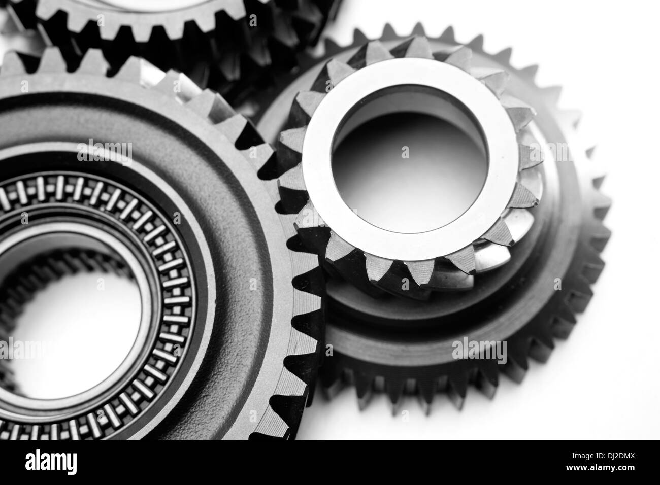 Metal cog gears joining together Stock Photo - Alamy