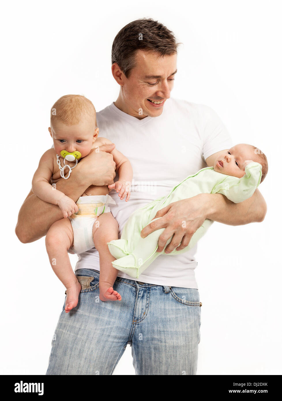 Smiling young man with two baby boys over white Stock Photo - Alamy