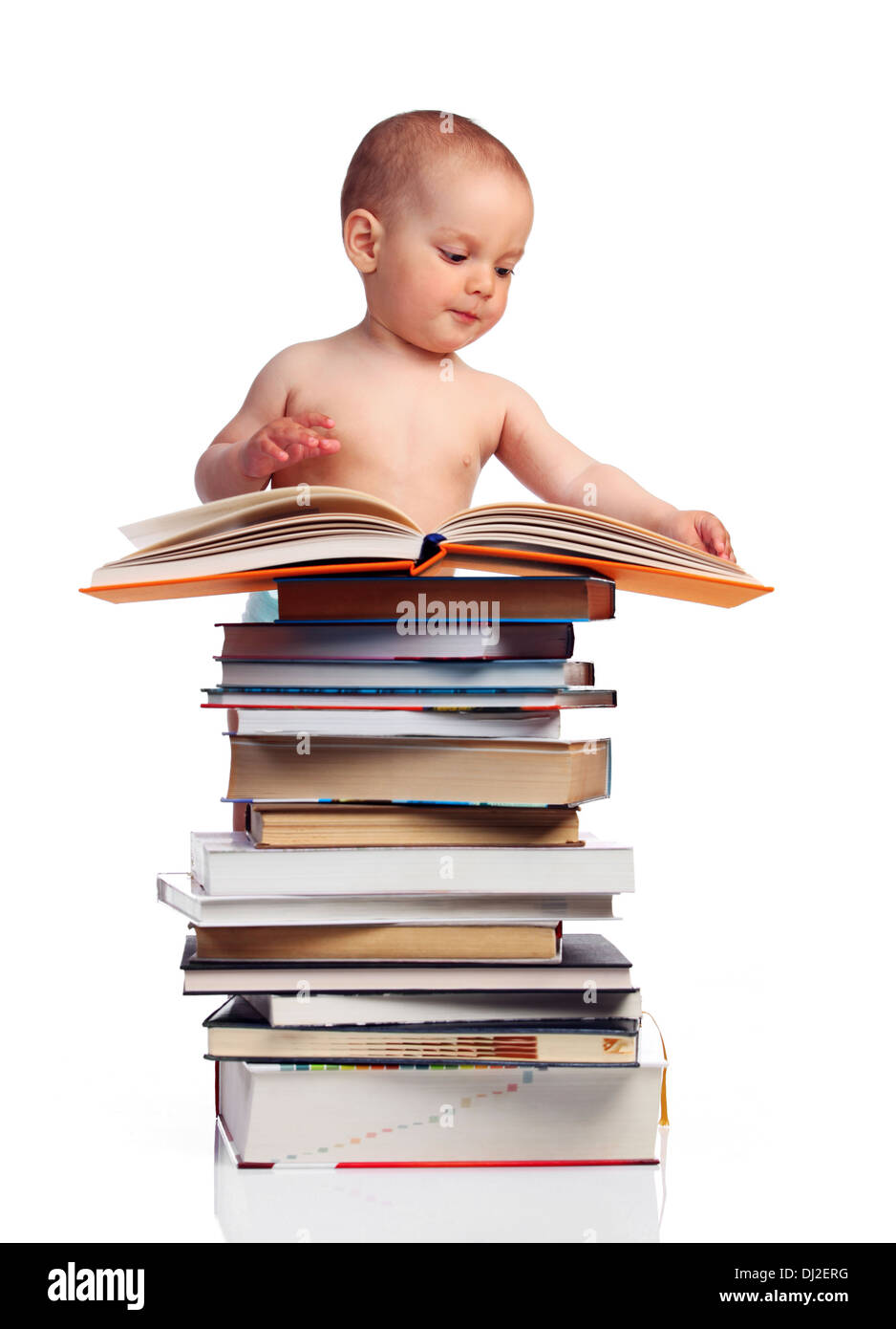 Portrait of a little boy standing behind a stack of books Stock Photo ...