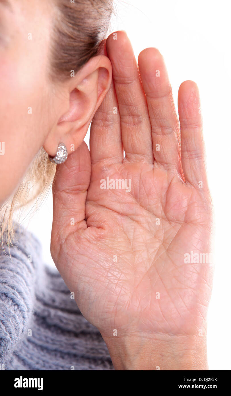 Listening: closeup view of female hand on her ear Stock Photo - Alamy