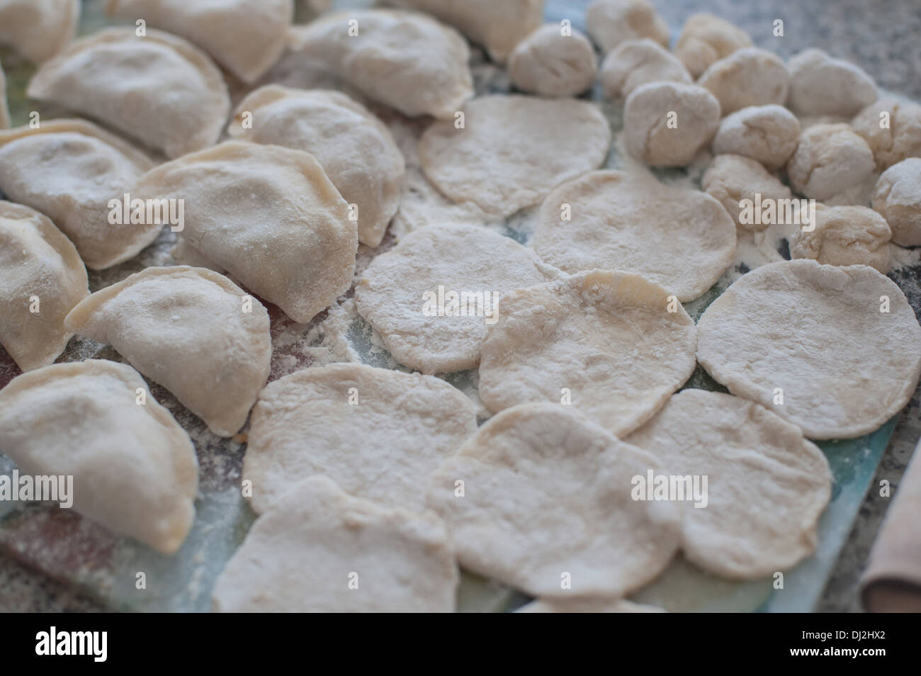 An image of raw dumplings and pieces of dumplings on the board Stock ...