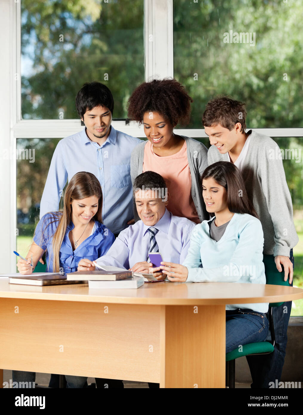 Teacher Explaining Students In Classroom Stock Photo - Alamy
