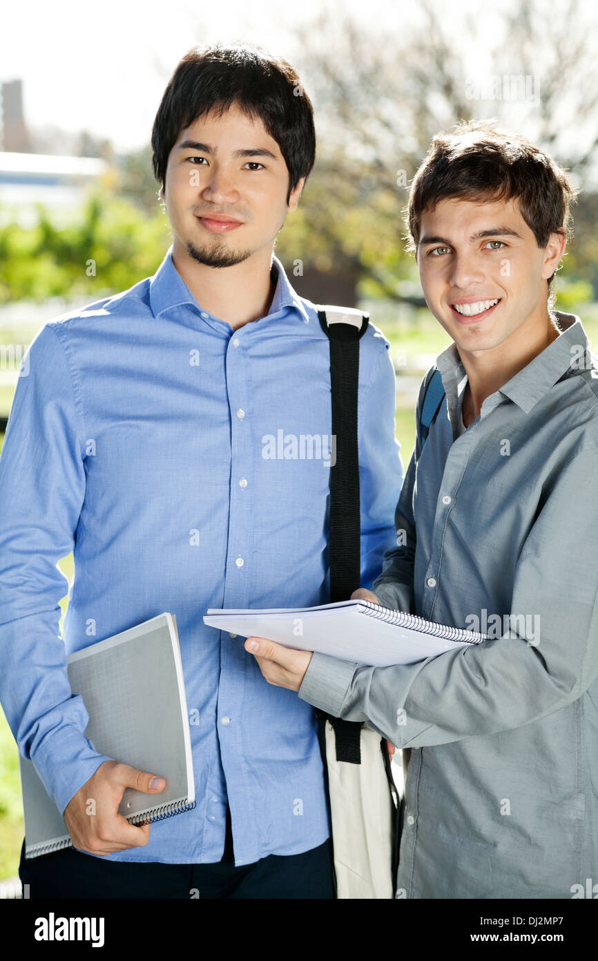 Students With Books Standing On College Campus Stock Photo - Alamy