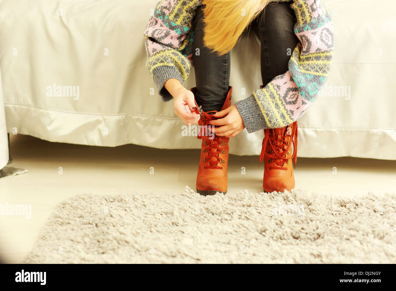 Woman taking off her boots hi-res stock photography and images - Alamy