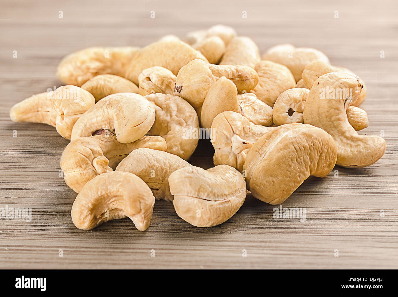 A handful of row cashew nuts on wood background . Images collected from ...