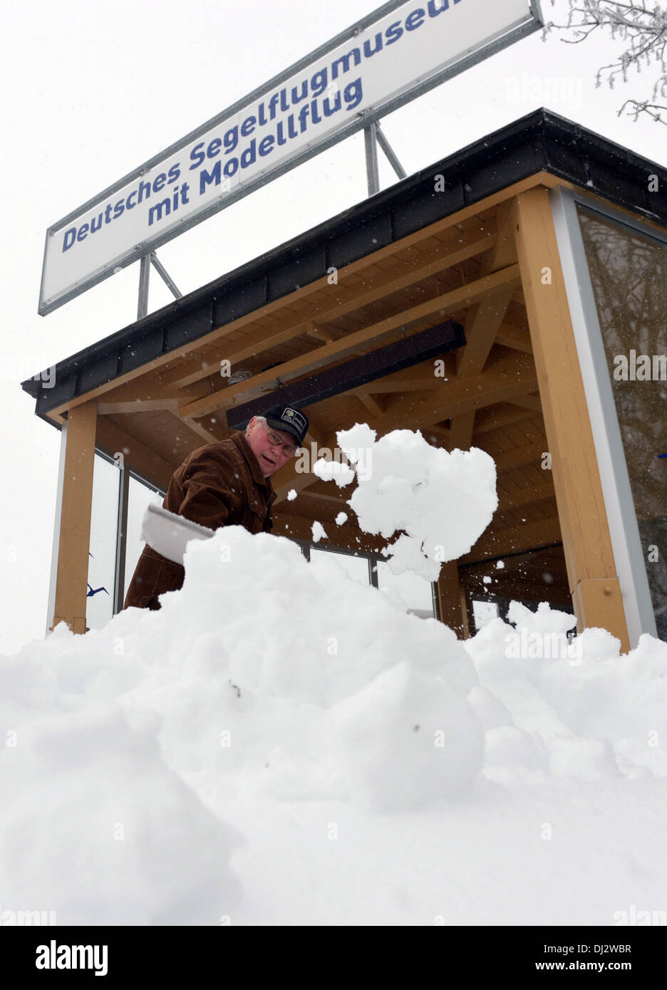 Gersfeld, Germany. 20th Nov, 2013. Lothar Schoen clears snow from the ...