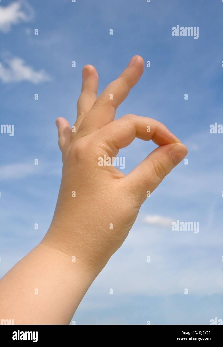 Human hand making OK sign against blue sky Stock Photo - Alamy